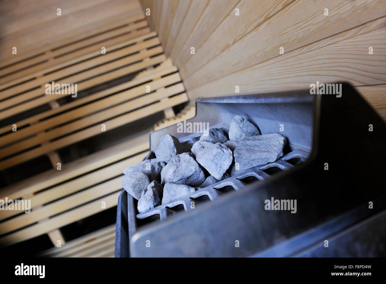 wooden luxury sauna indoor with hot stones and falling splashing water ...