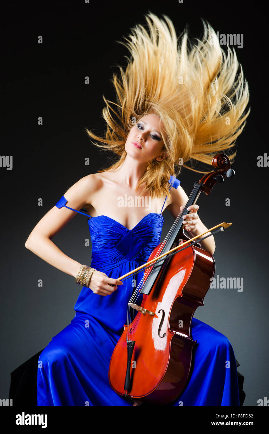 Attractive woman with cello in studio Stock Photo - Alamy