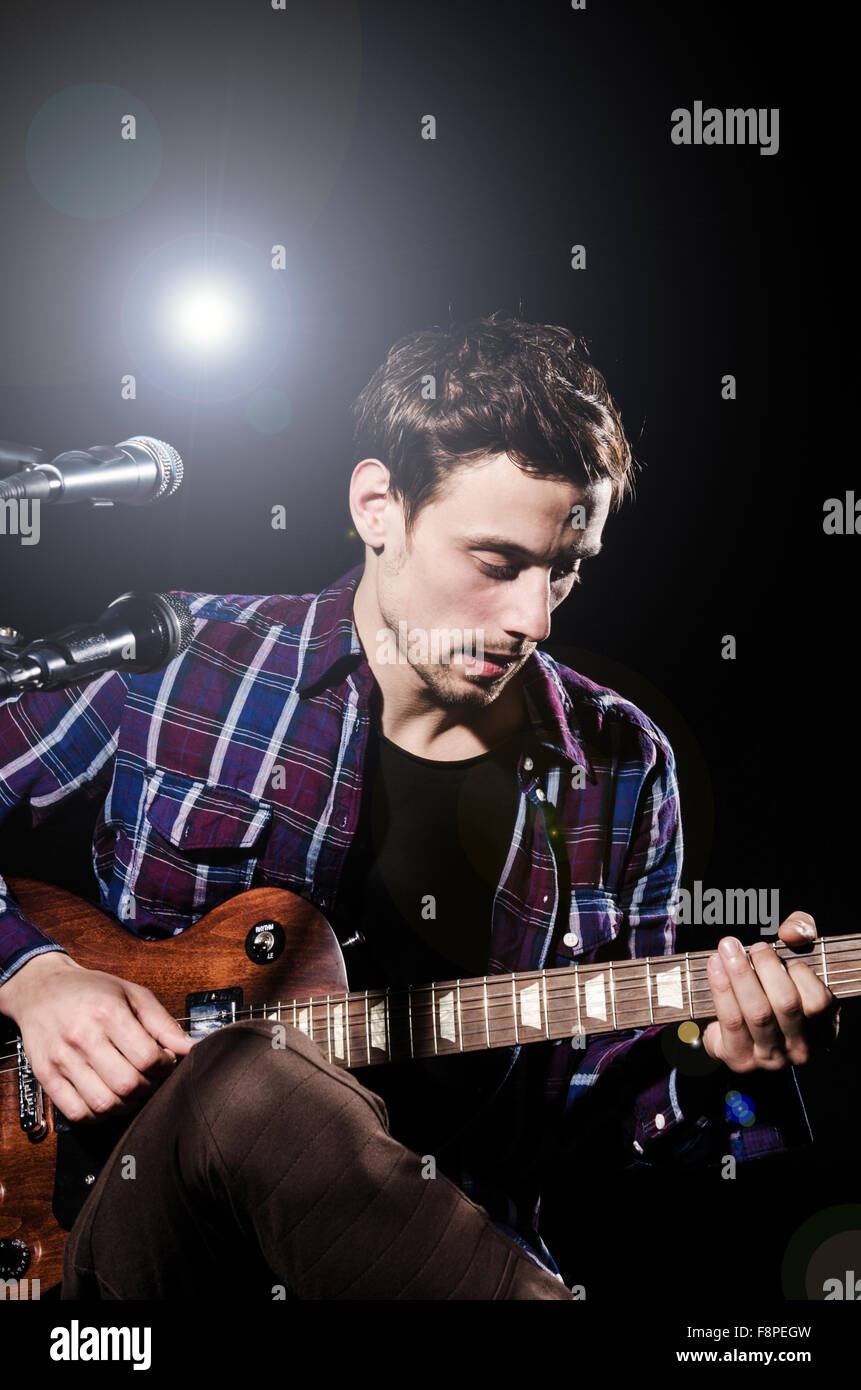 Man playing guitar during concert Stock Photo - Alamy