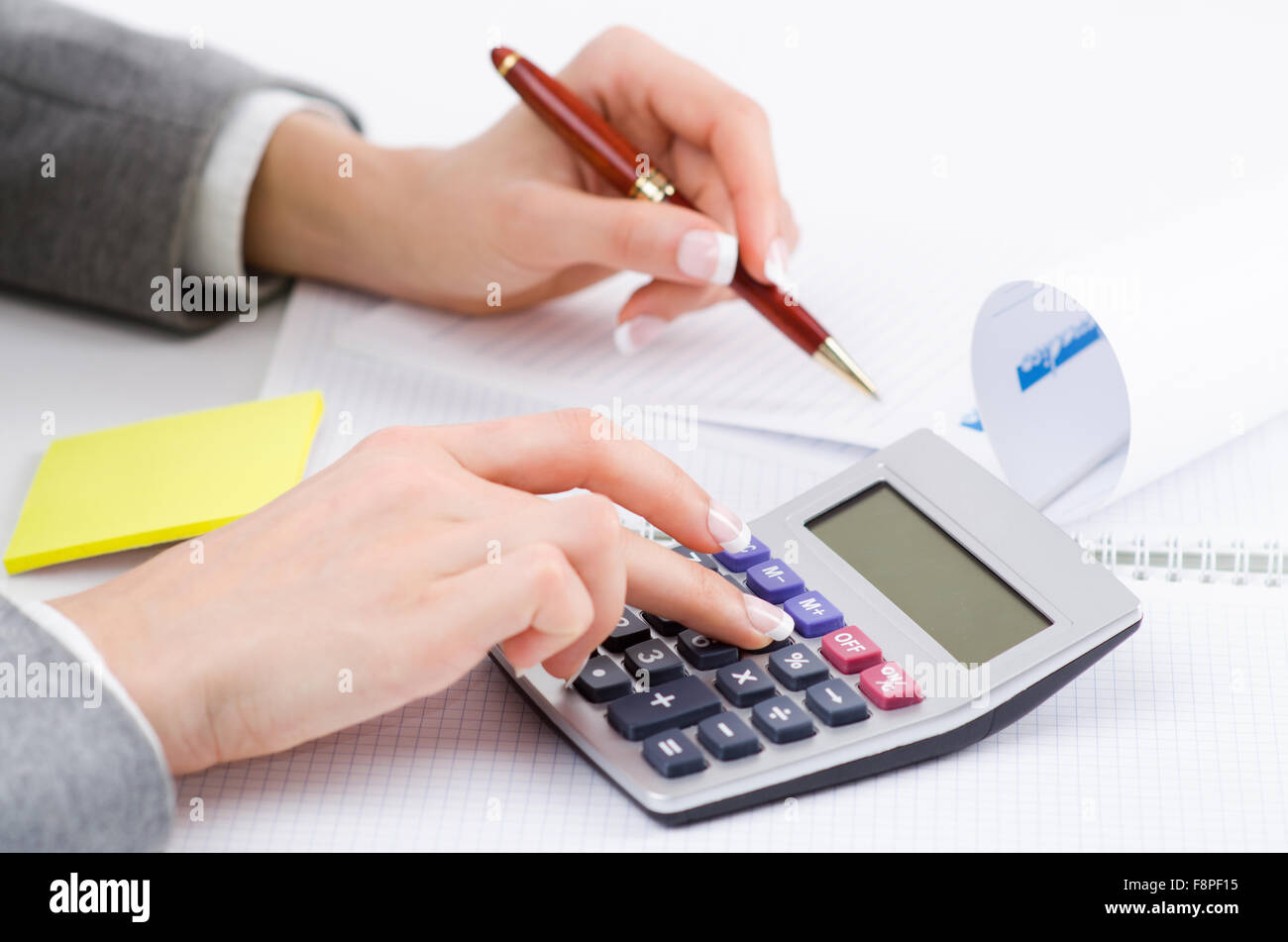 Hands working on the calculator Stock Photo - Alamy