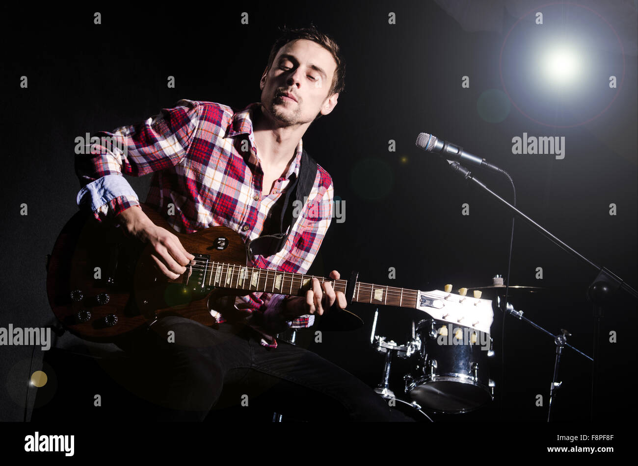 Man playing guitar during concert Stock Photo - Alamy