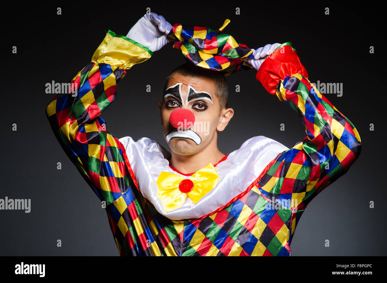 Sad clown against dark background Stock Photo - Alamy
