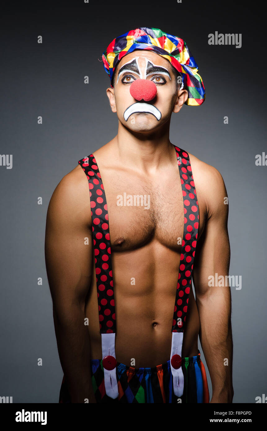 Sad clown against dark background Stock Photo - Alamy