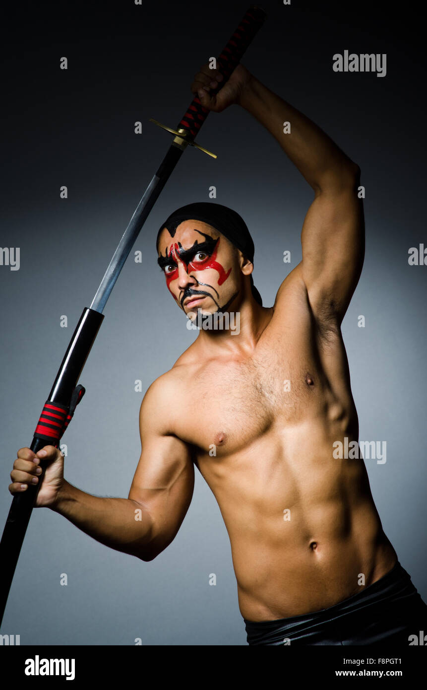 Man with sword and face paint Stock Photo - Alamy