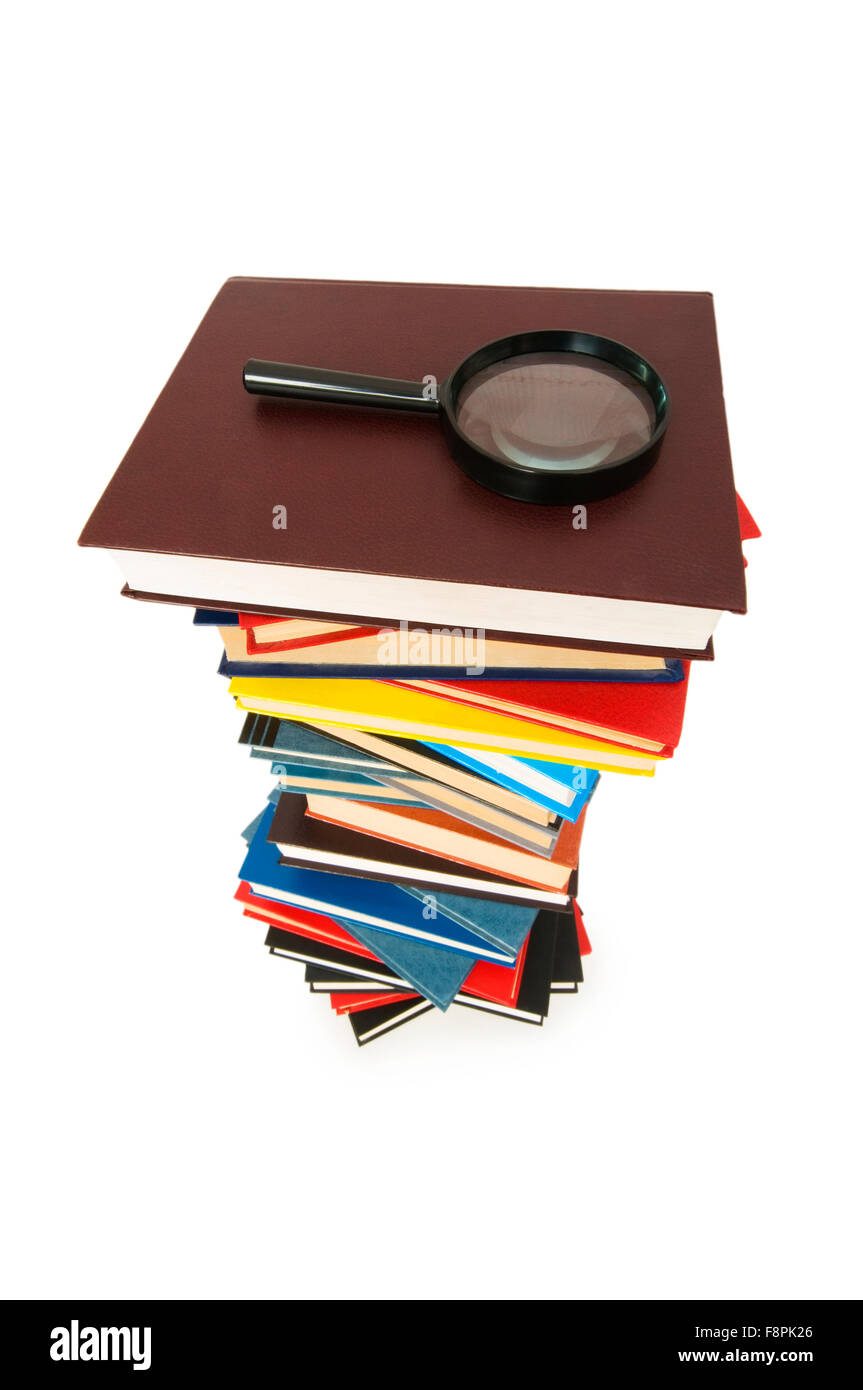 Magnifying glass over the stack of books Stock Photo - Alamy