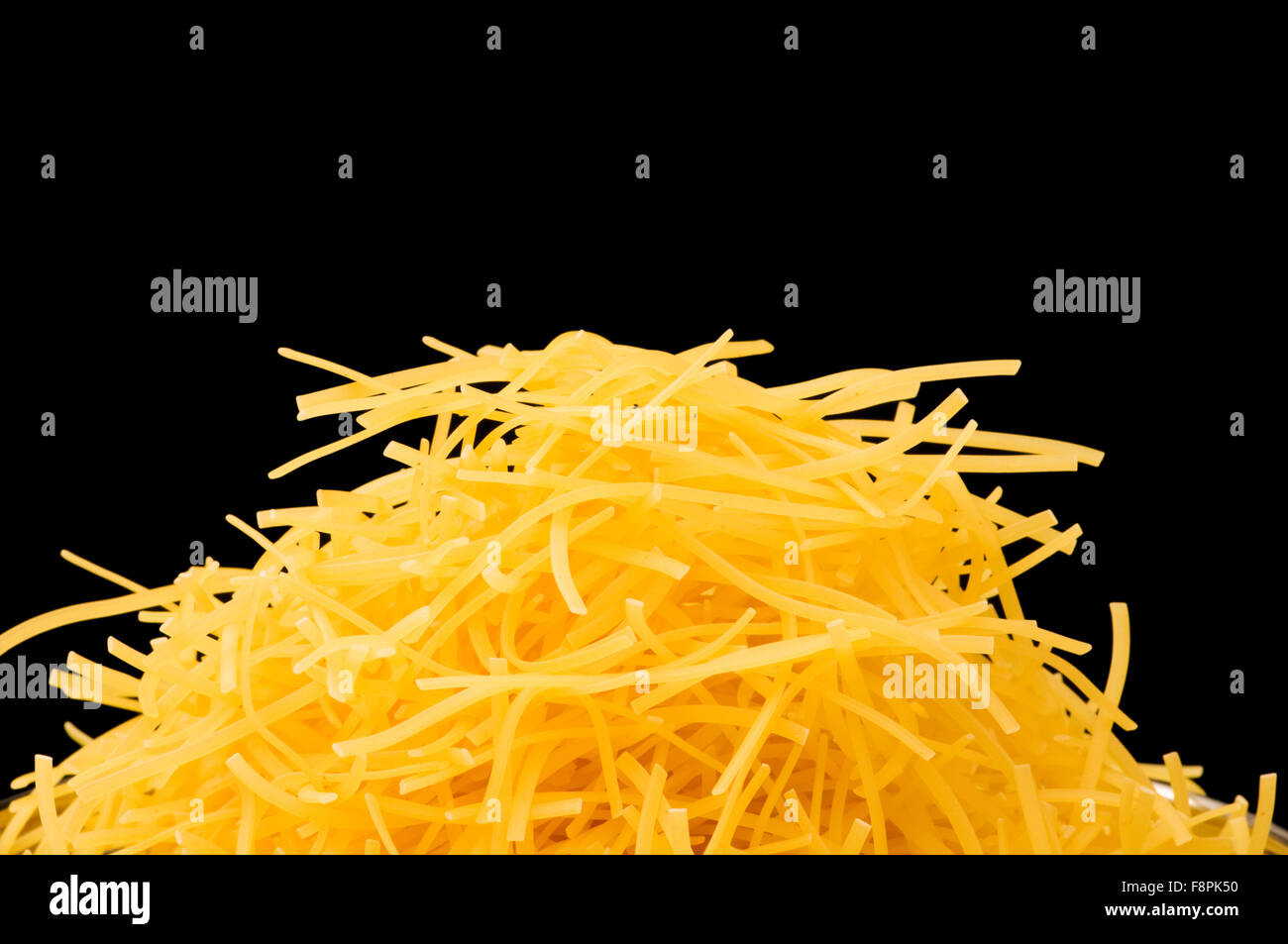 Pasta pile isolated on the black background Stock Photo - Alamy