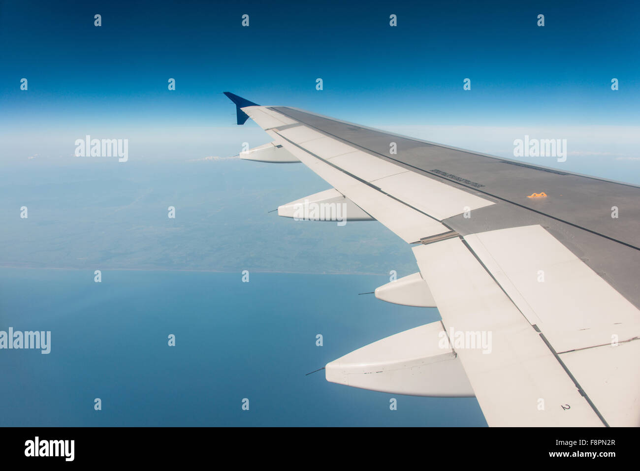 Airplane wing out of window Stock Photo - Alamy