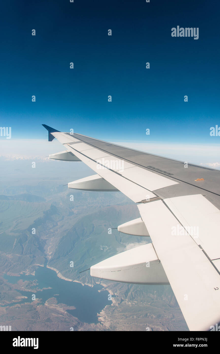 Airplane wing out of window Stock Photo - Alamy