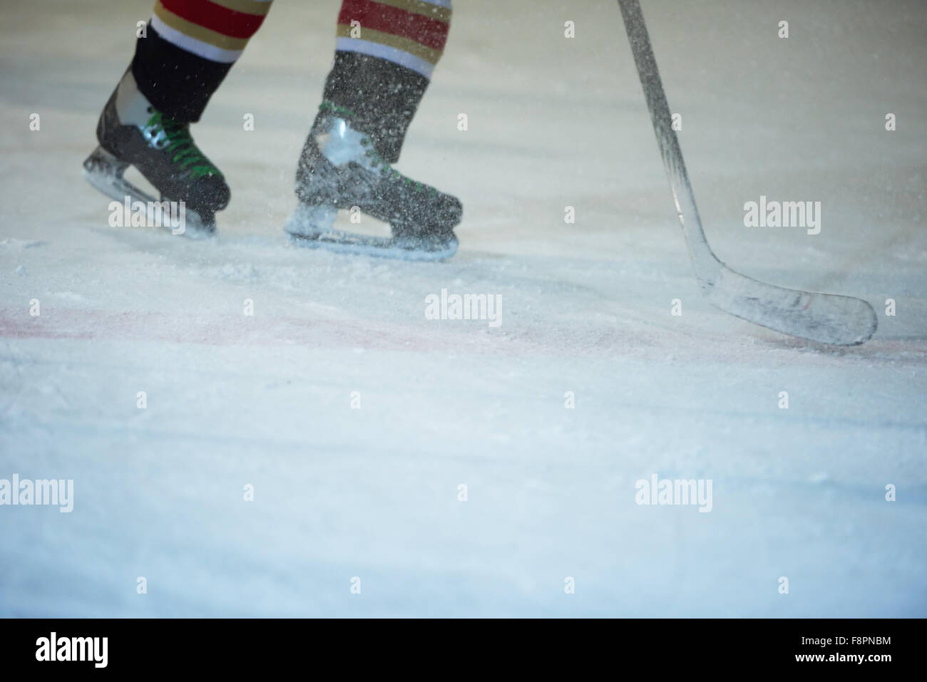 ice hockey player in action kicking with stick Stock Photo - Alamy