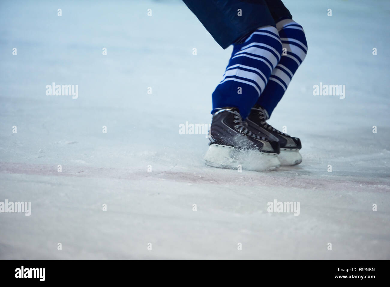 ice hockey player in action kicking with stick Stock Photo - Alamy