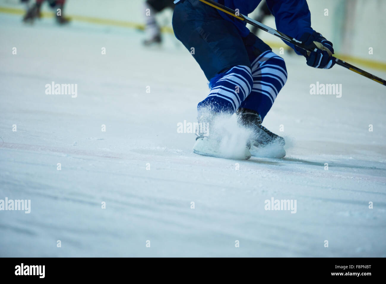 ice hockey player in action kicking with stick Stock Photo - Alamy