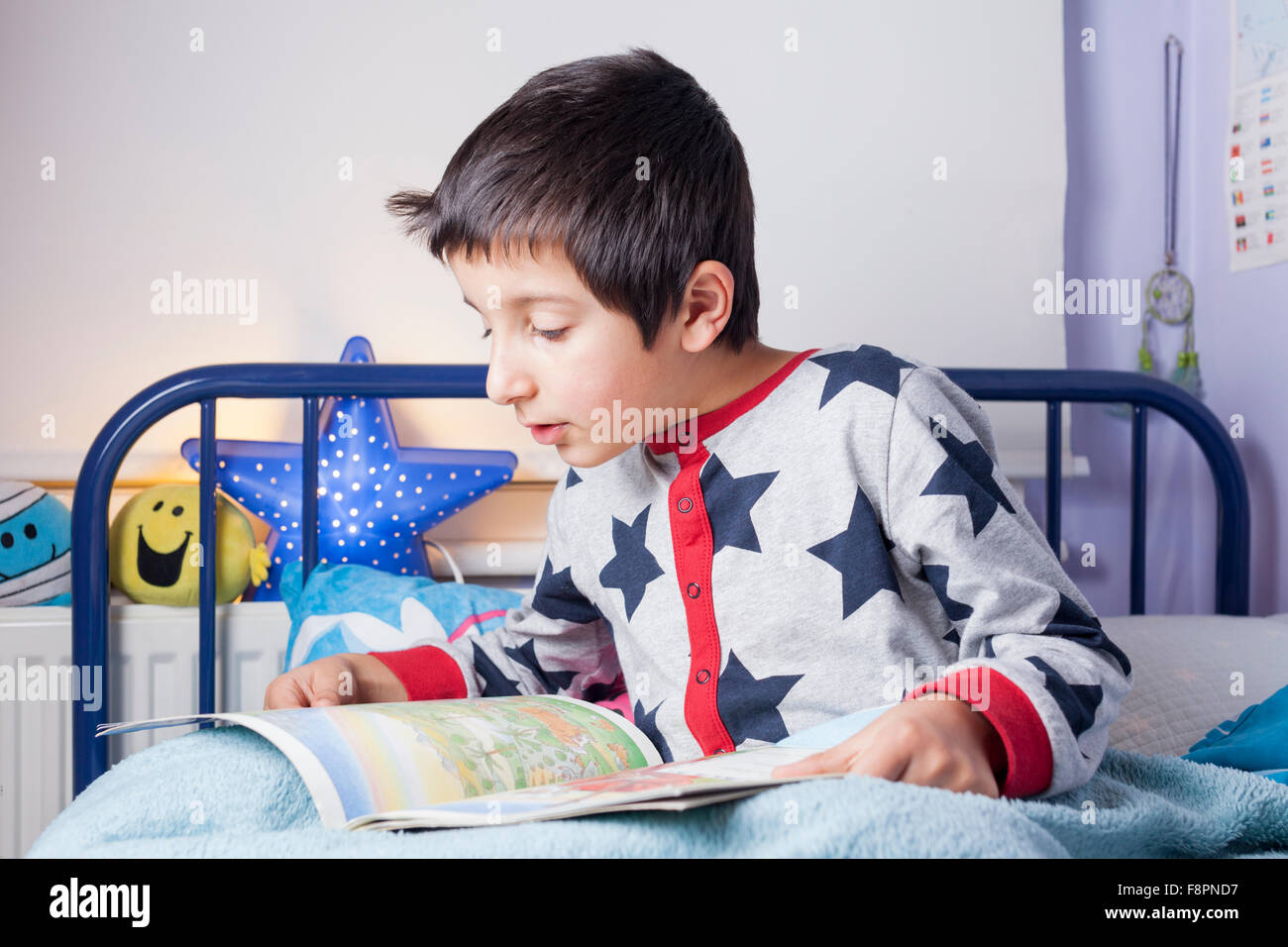 Boy reading bedtime story Stock Photo - Alamy