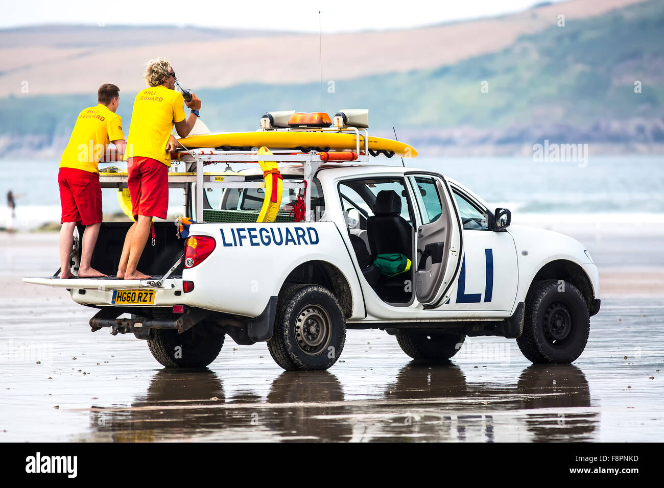RNLI Lifeguards on duty at Polzeath Beach in Cornwall Stock Photo - Alamy