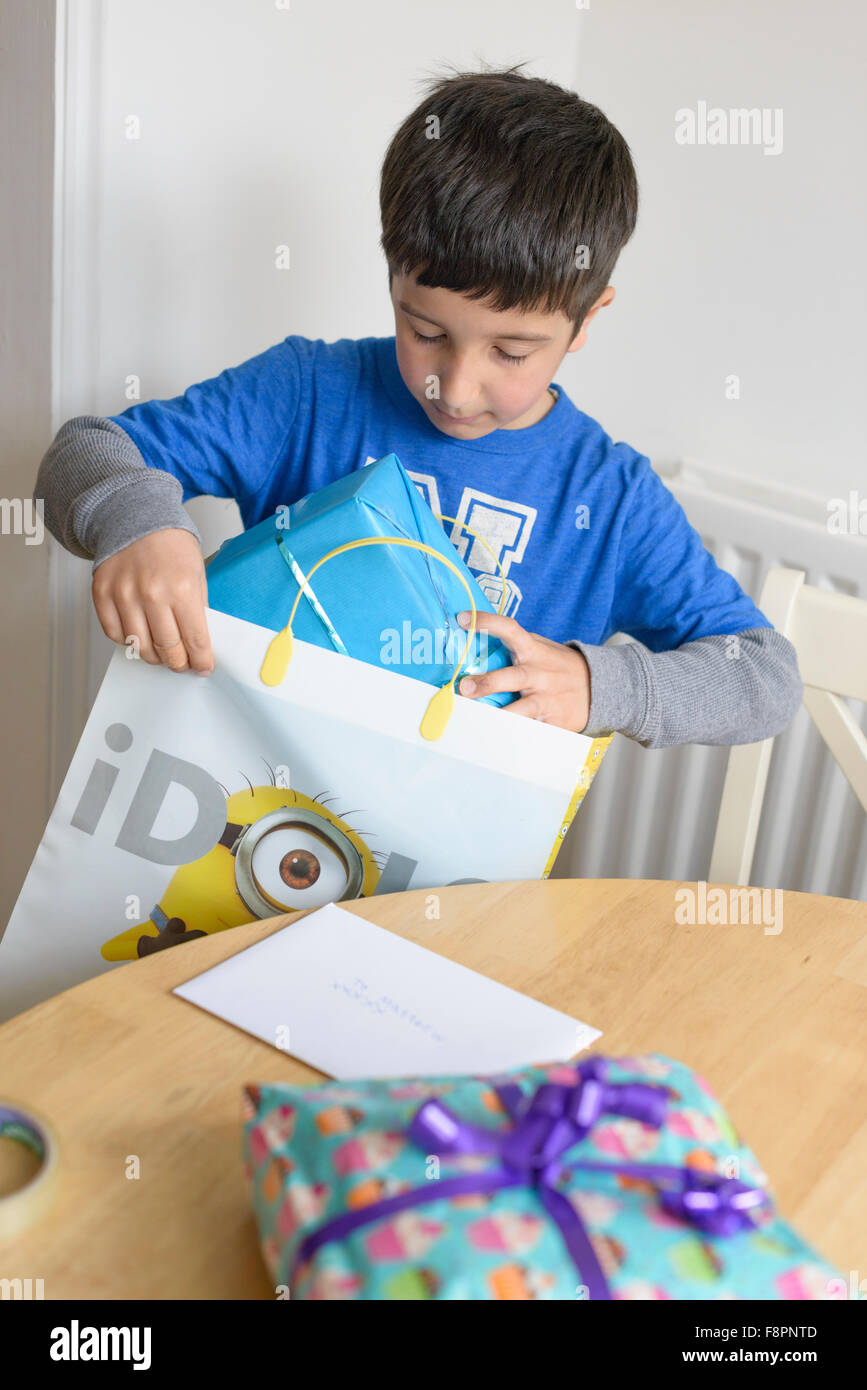 Child unpacking presents Stock Photo - Alamy