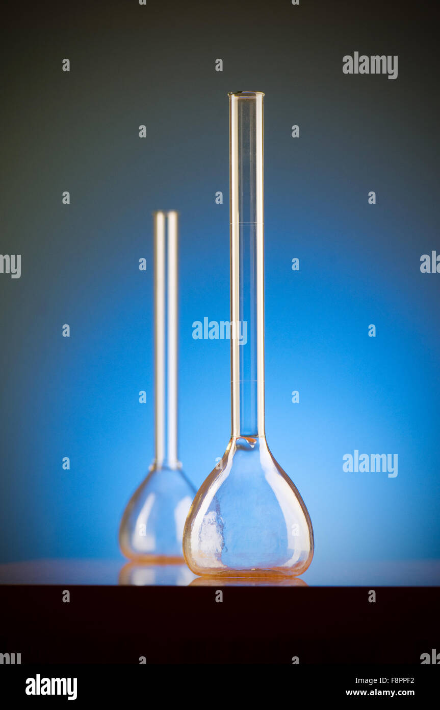 Glass retorts against blue gradient background Stock Photo - Alamy