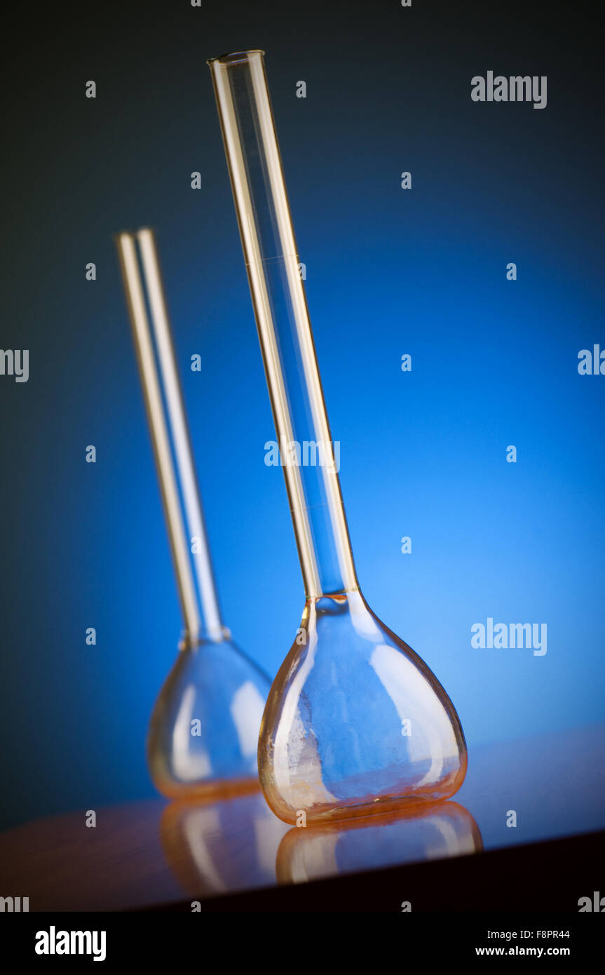 Glass retorts against blue gradient background Stock Photo - Alamy