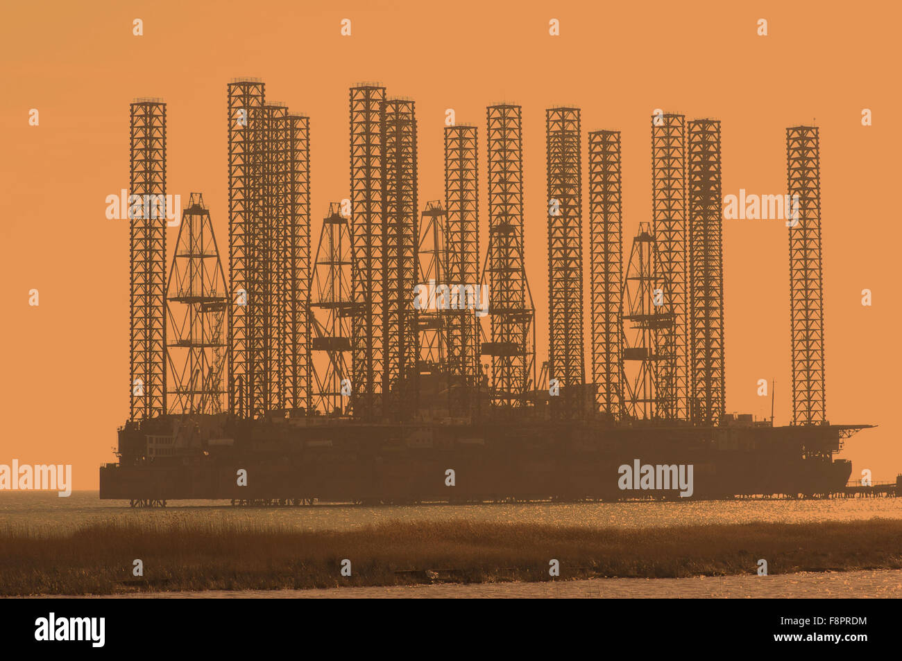 Offshore oil rig at shallow waters during sunset Stock Photo - Alamy