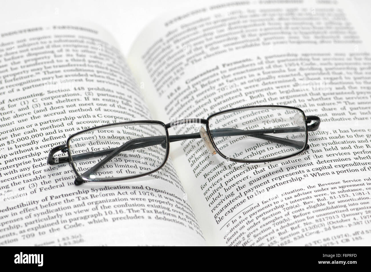 Reading glasses with light frame over the open book Stock Photo - Alamy