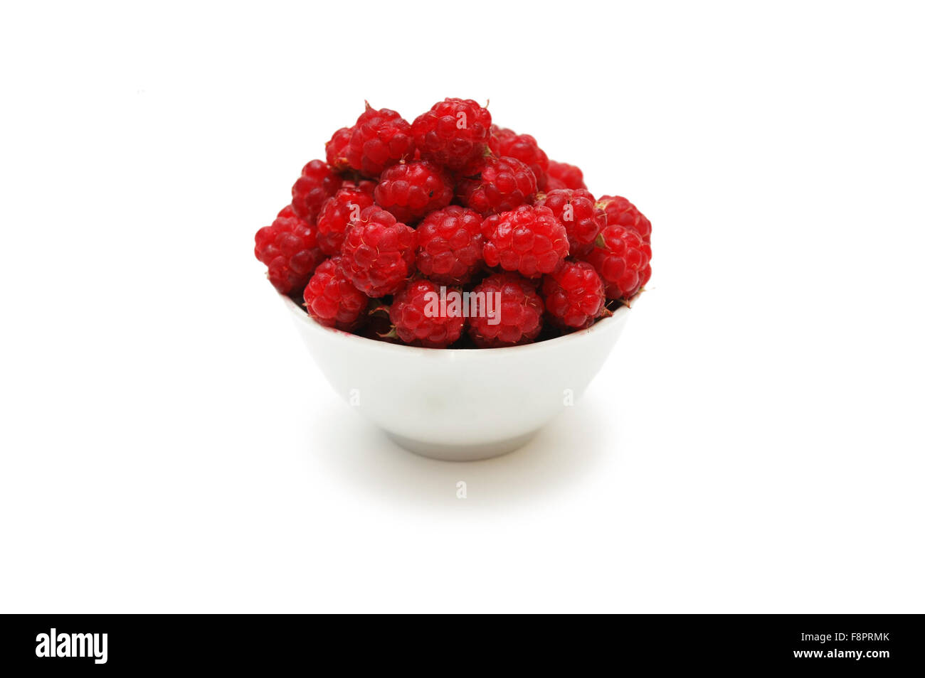 Bowl full of raspberries isolated on white Stock Photo - Alamy