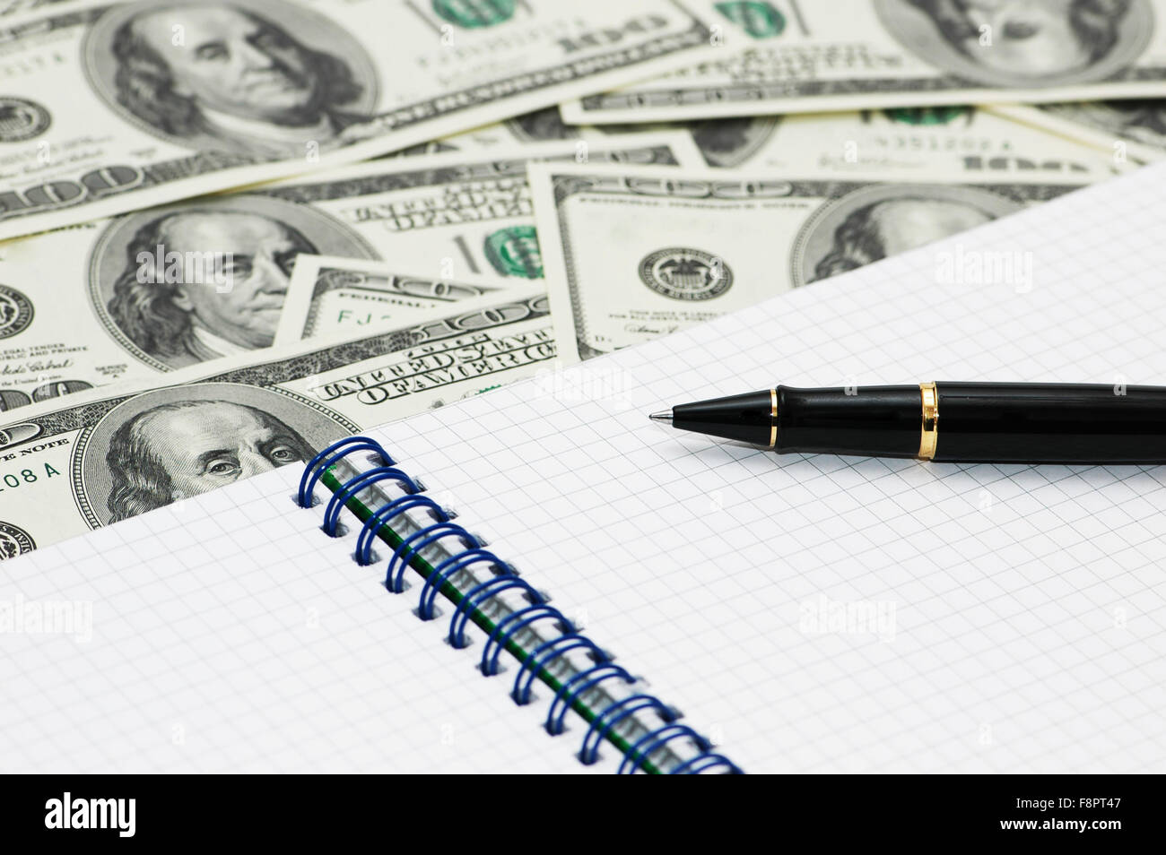 American dollars, ball pen and notebook Stock Photo - Alamy