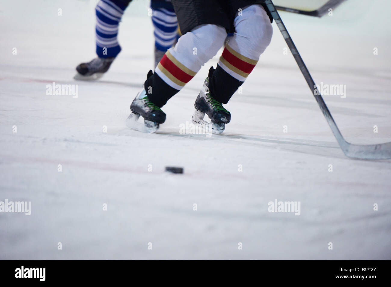 ice hockey player in action kicking with stick Stock Photo - Alamy