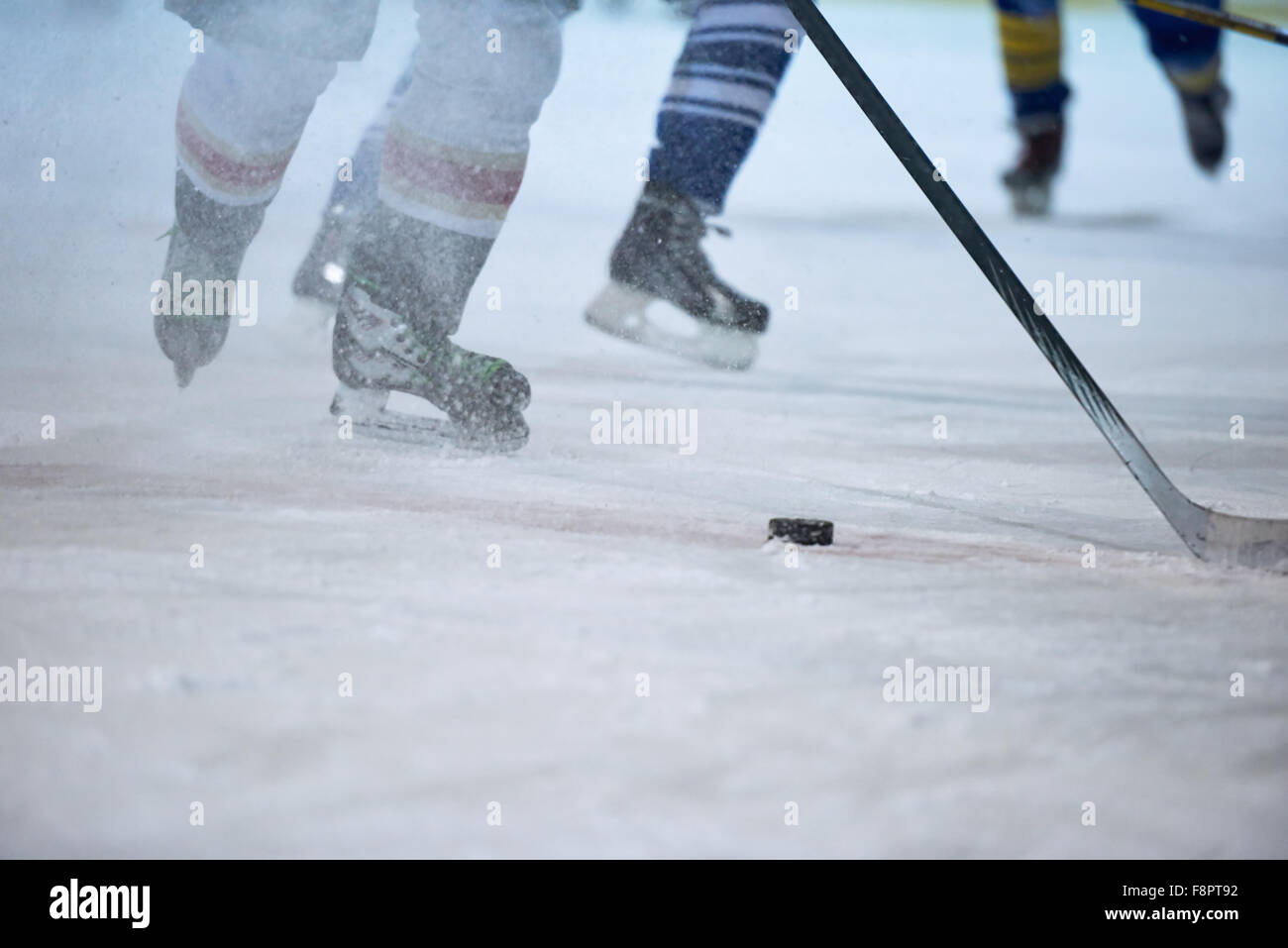 ice hockey player in action kicking with stick Stock Photo - Alamy