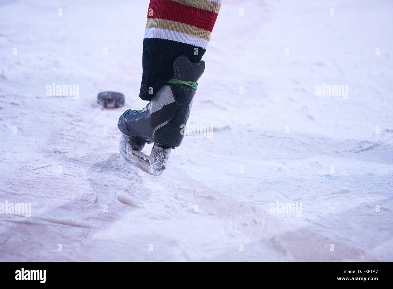 ice hockey player in action kicking with stick Stock Photo - Alamy