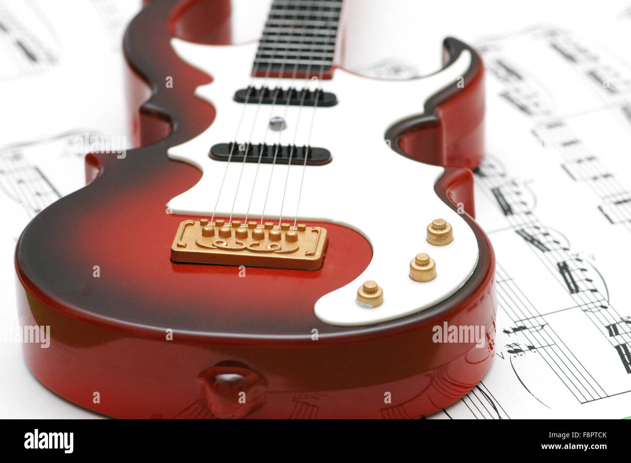 Wooden string guitar over the musical notes Stock Photo - Alamy