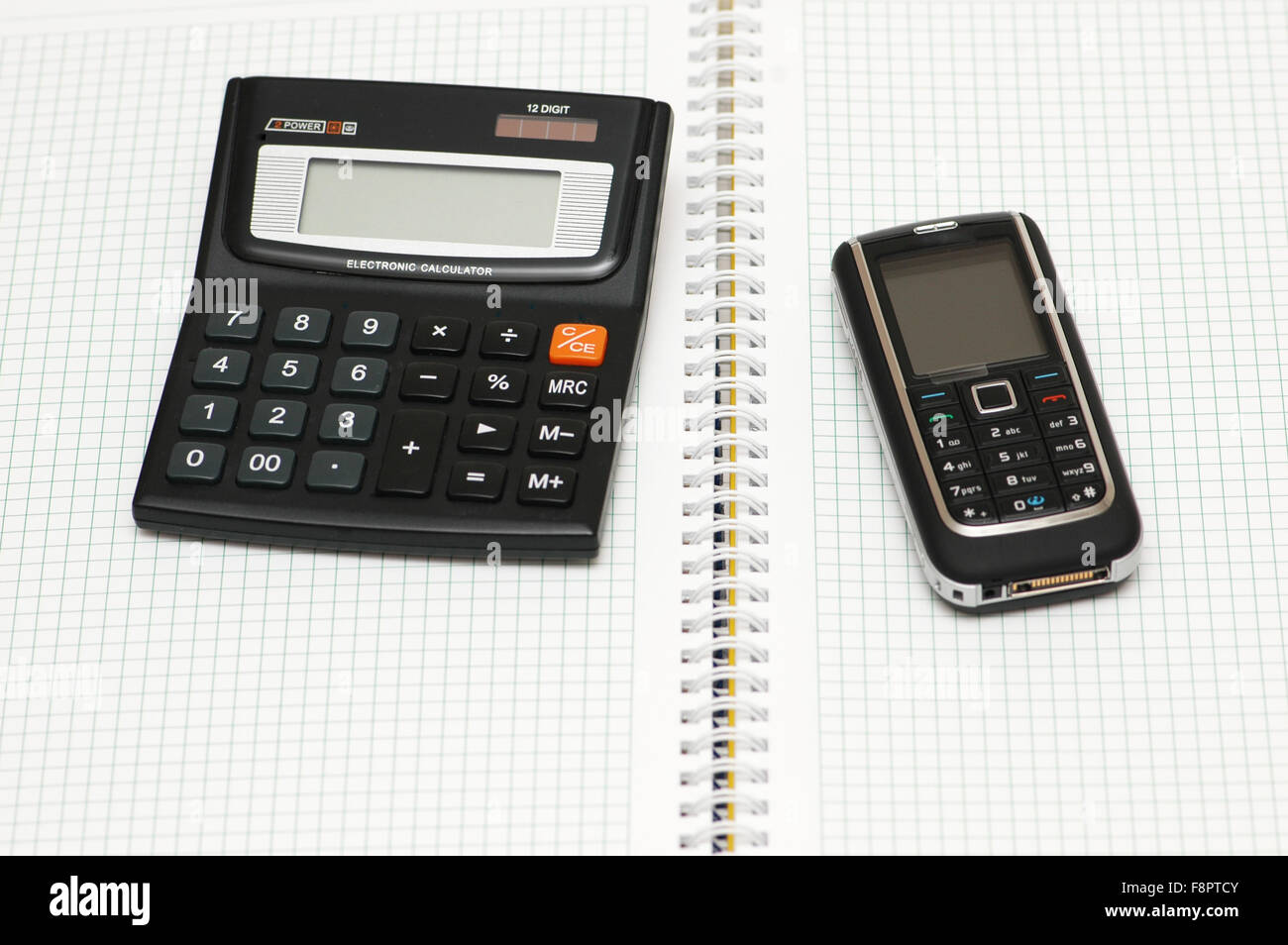 Mobile phone, calculator and pen on the notebook Stock Photo - Alamy