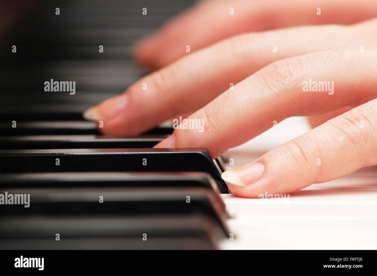 Two hands playing music on the piano Stock Photo - Alamy