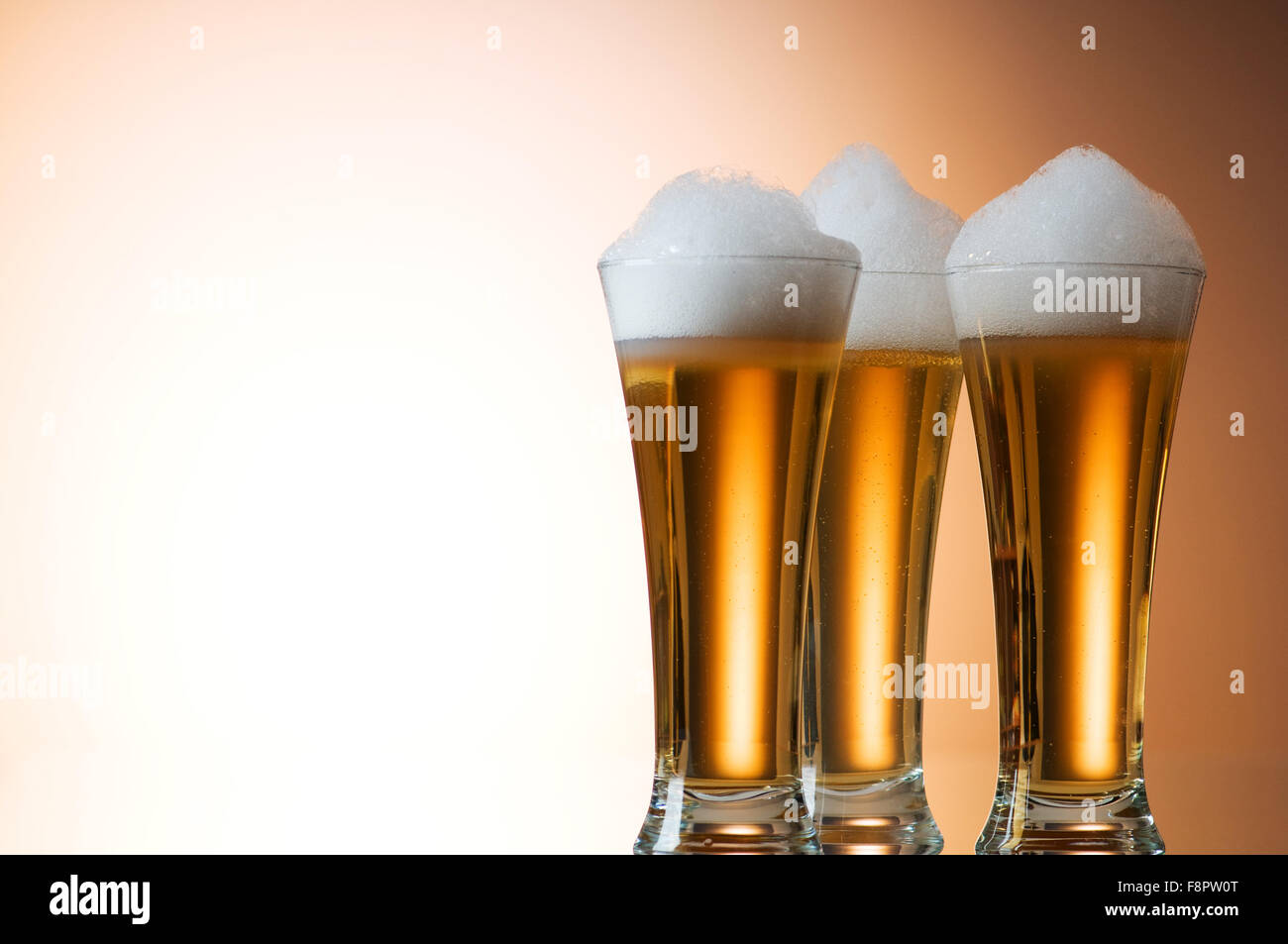 Beer glasses against the colorful gradient background Stock Photo - Alamy