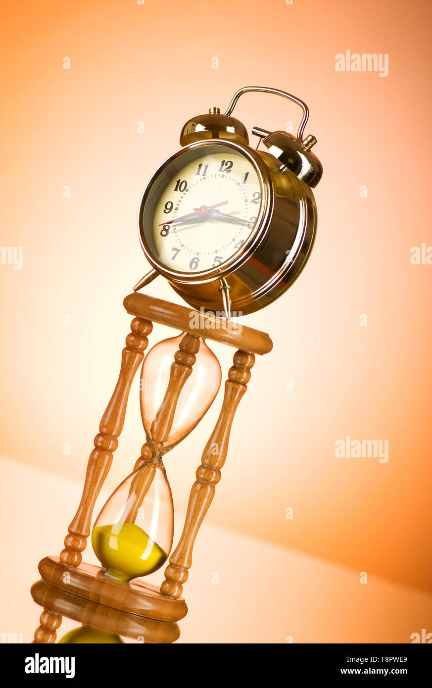 Time concept with clock and hour glass Stock Photo - Alamy