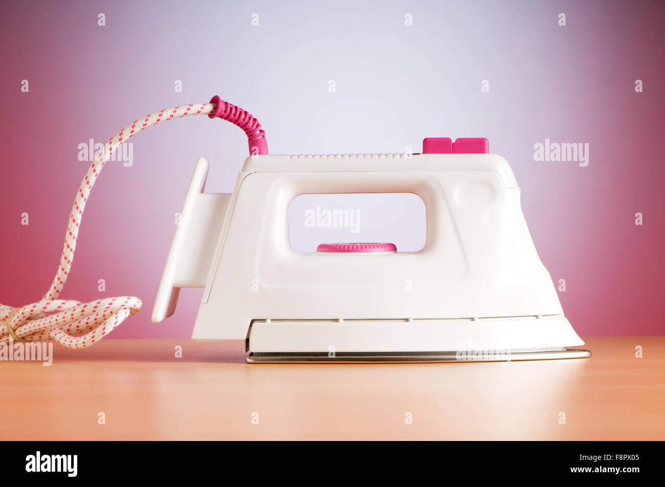 Modern electric iron against the colorful background Stock Photo - Alamy