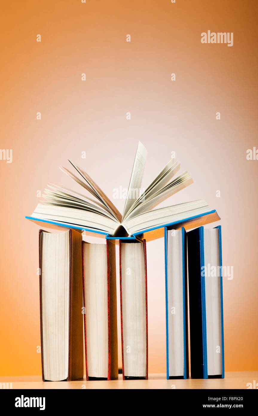 Stack of text books against gradient background Stock Photo - Alamy
