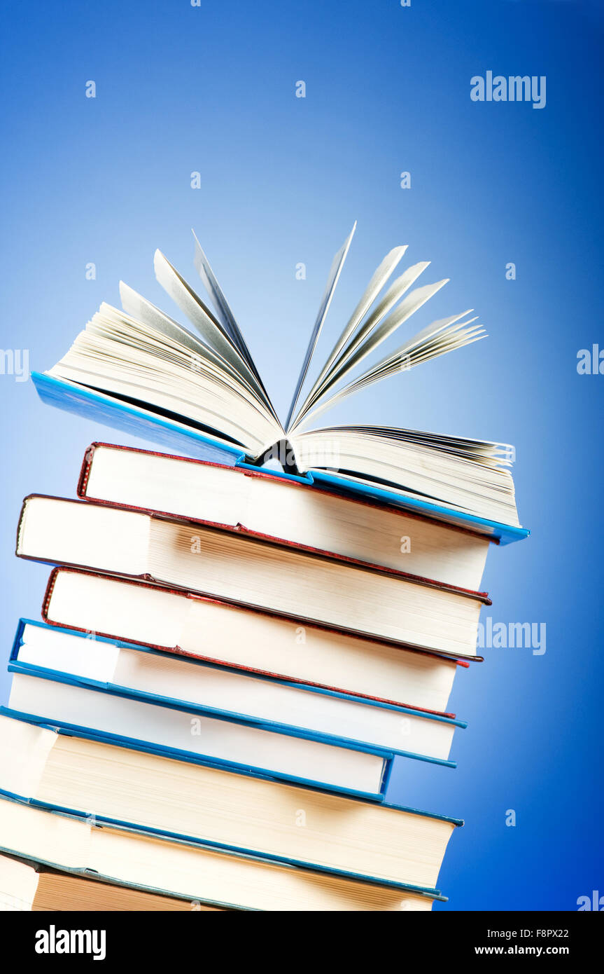 Stack of text books against gradient background Stock Photo - Alamy
