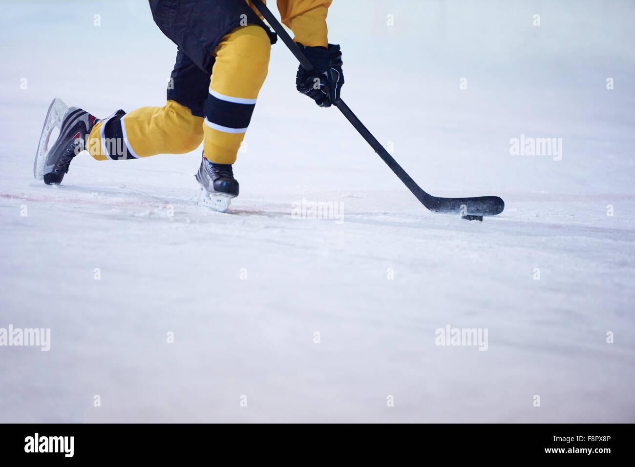 ice hockey player in action kicking with stick Stock Photo - Alamy