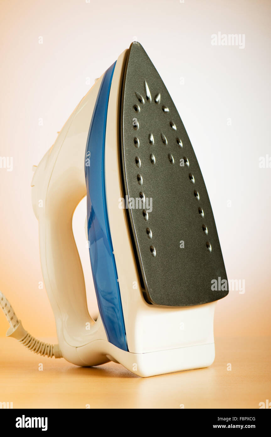 Modern electric iron against the colorful background Stock Photo - Alamy