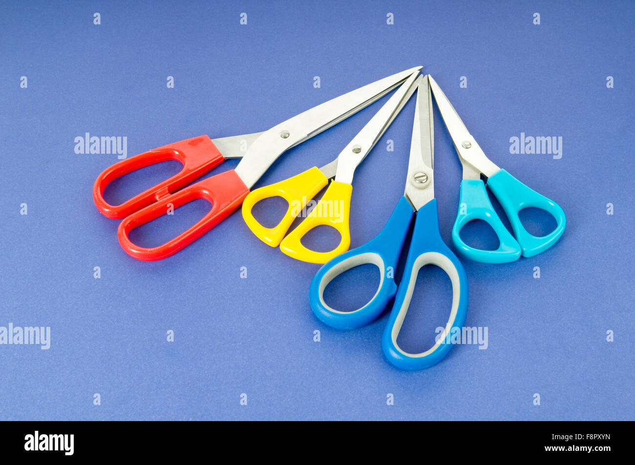 Colorful scissors on the color paper background Stock Photo - Alamy