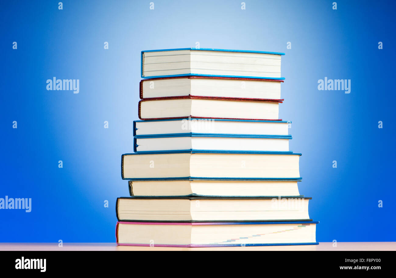 Stack of text books against gradient background Stock Photo - Alamy