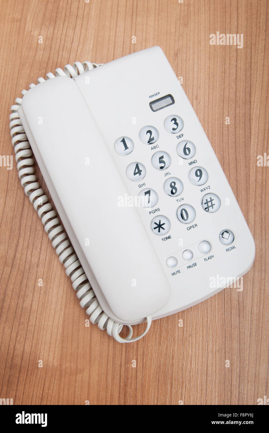 White office phone on the flat surface Stock Photo - Alamy