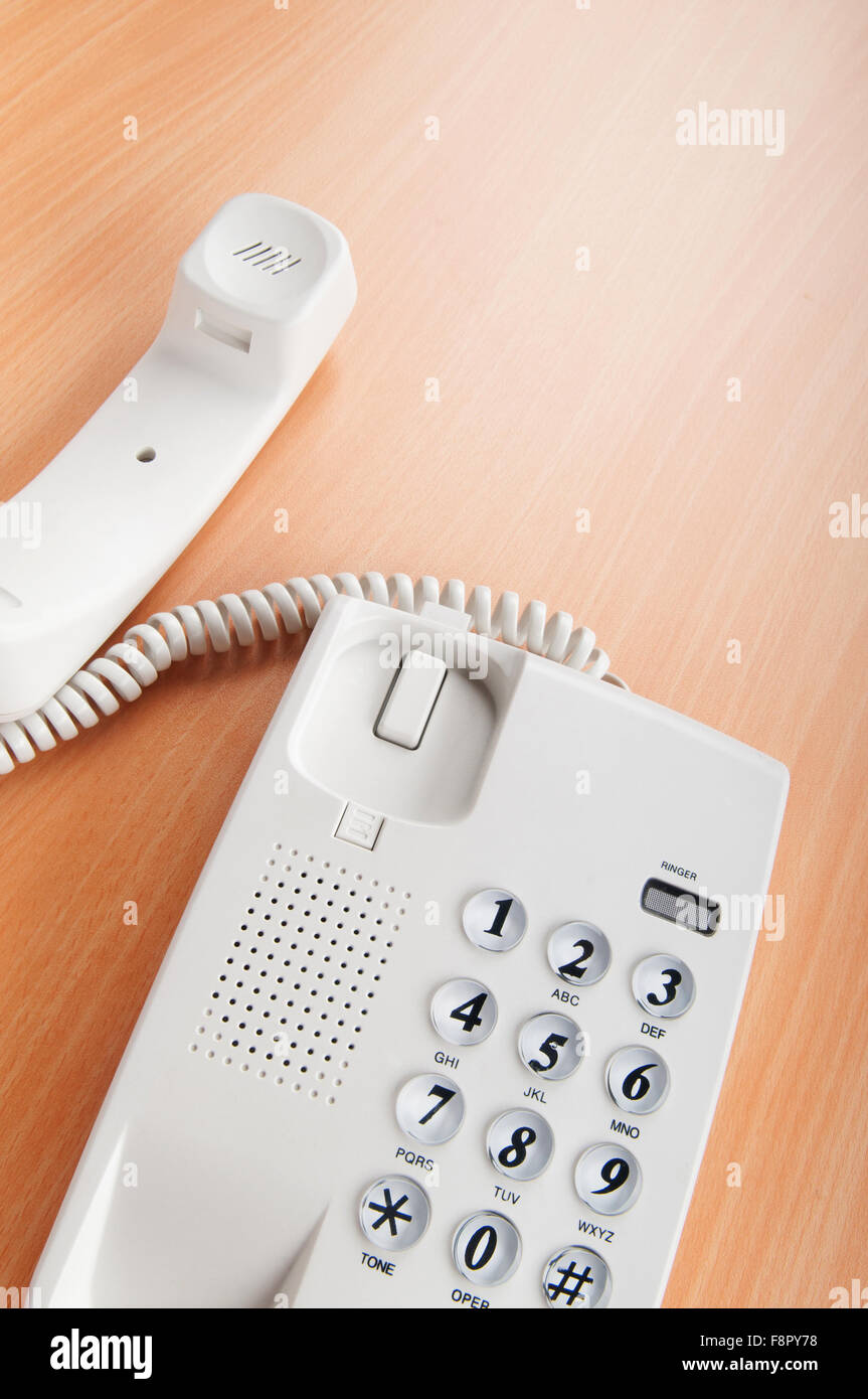 White office phone on the flat surface Stock Photo - Alamy