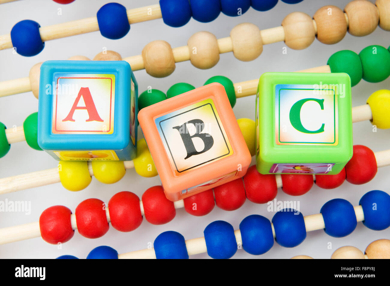 Alphabet blocks and abacus isolated on white Stock Photo - Alamy