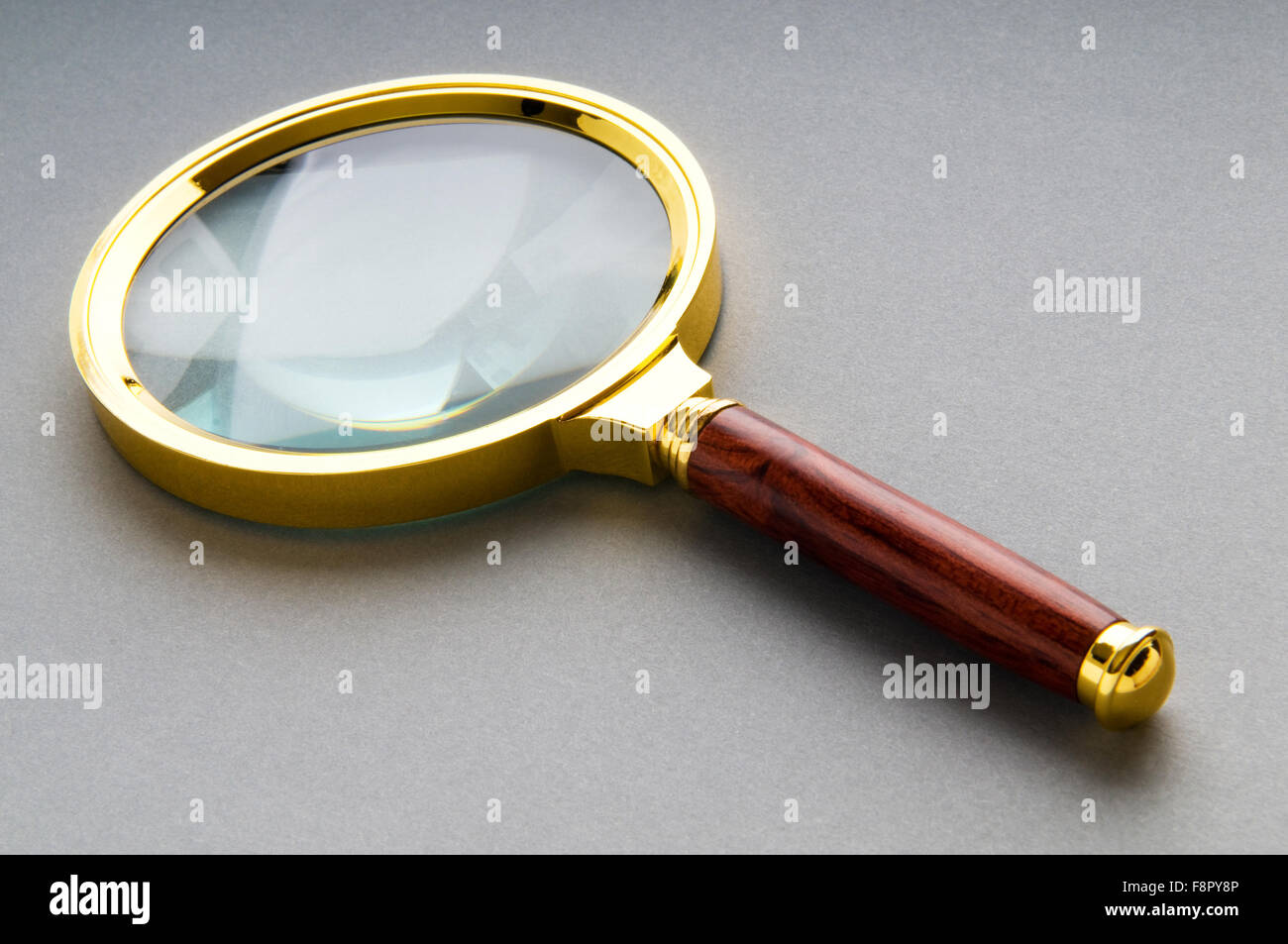 Magnifying glass with wooden handle on the flat surface Stock Photo - Alamy