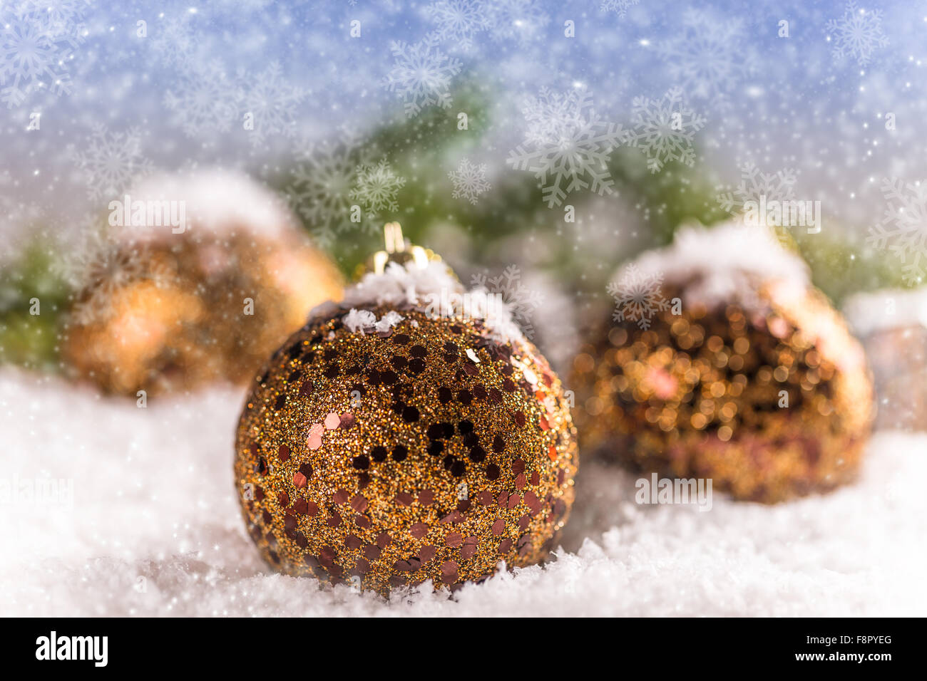 Gilded Christmas ball in the snow Stock Photo - Alamy