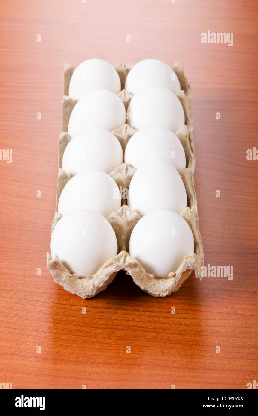 Many white eggs on the wooden table Stock Photo - Alamy