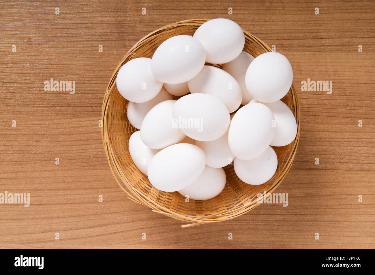 Many white eggs on the wooden table Stock Photo - Alamy