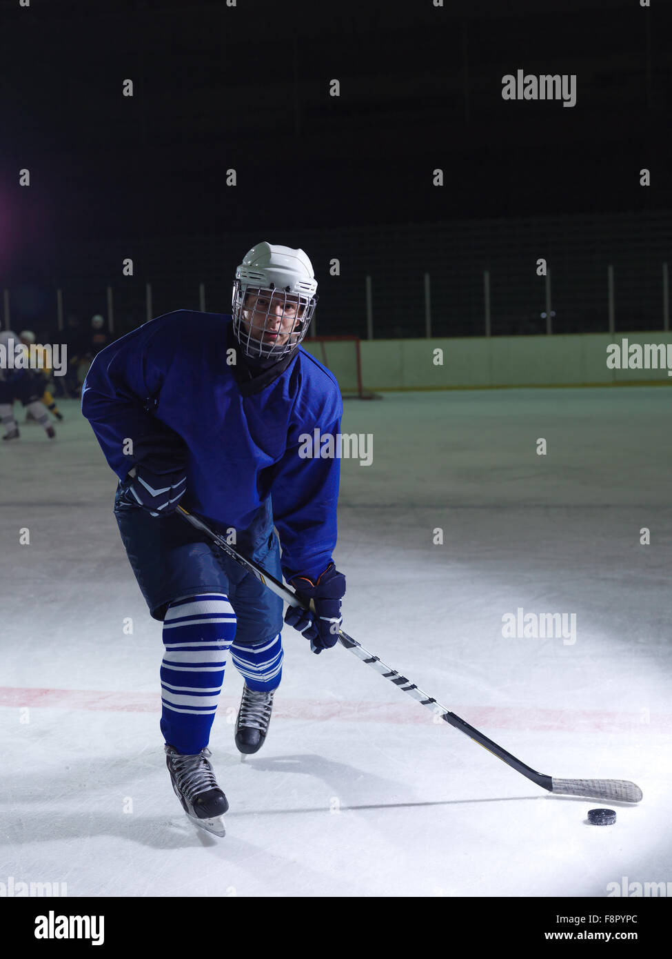 ice hockey player in action kicking with stick Stock Photo - Alamy