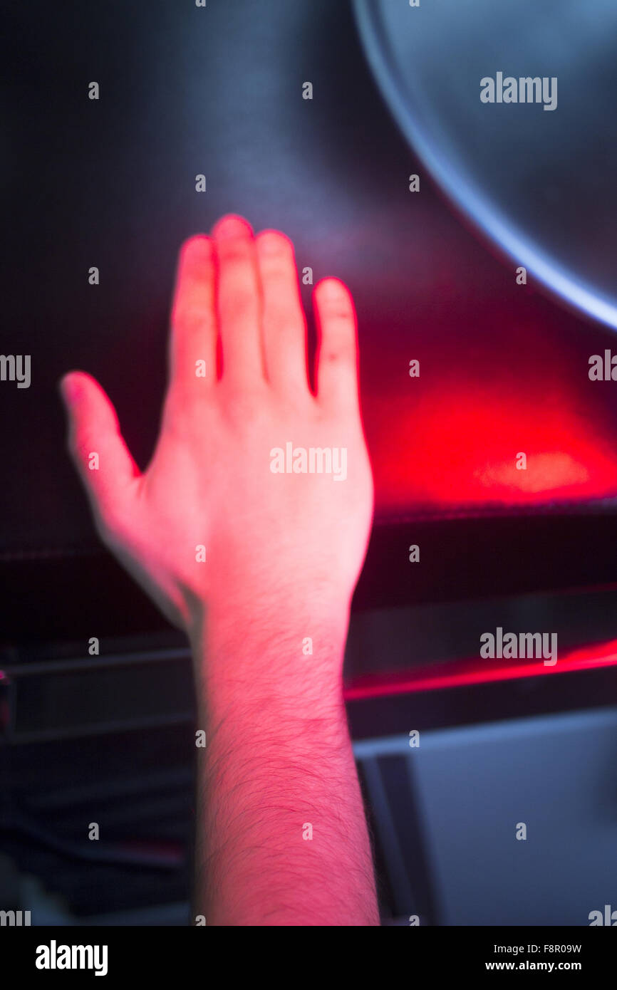 Patient hand in red physiotherapy heat treatment under hot light Stock ...