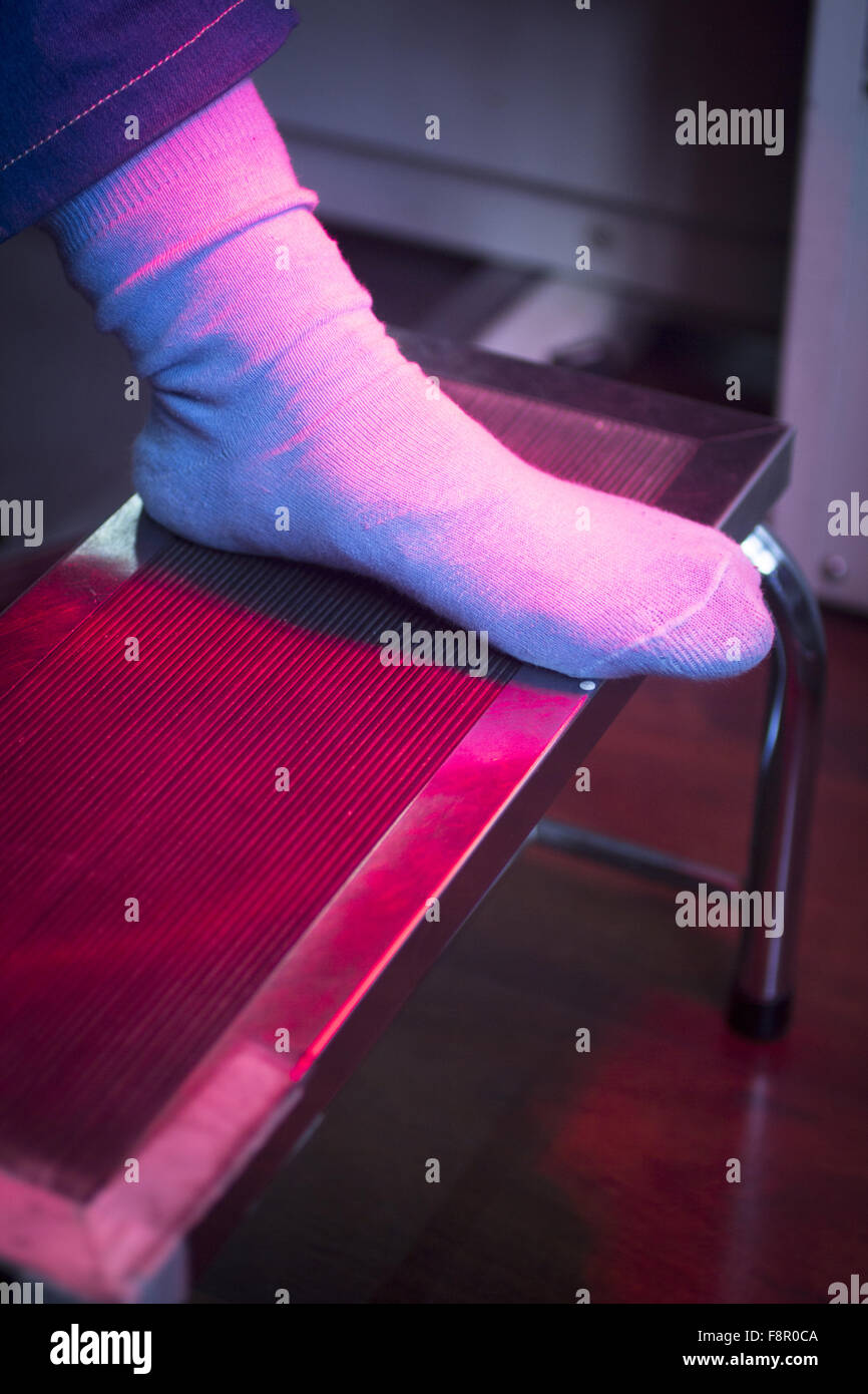 Patient foot in red physiotherapy heat treatment under hot light Stock ...