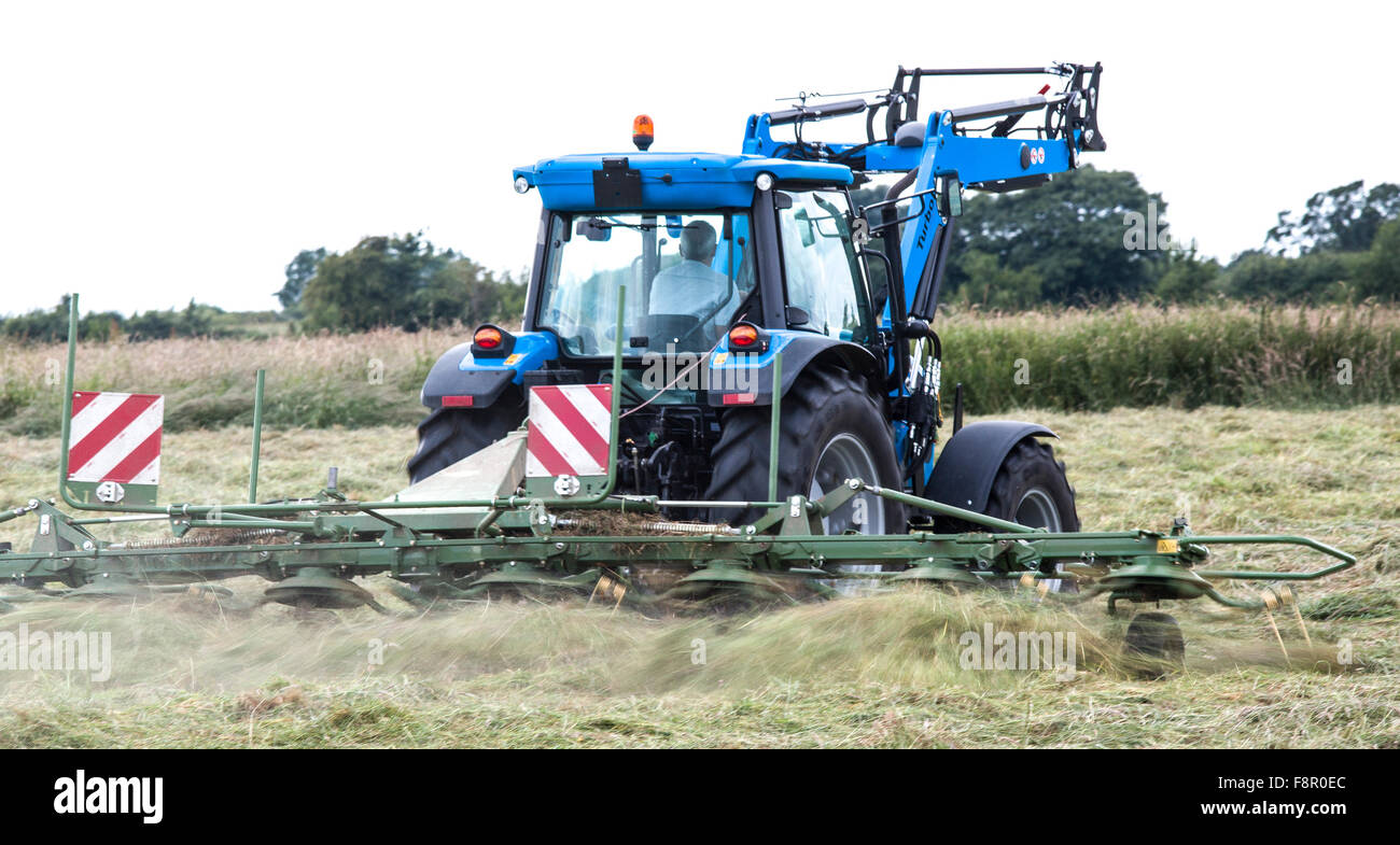 Tedder turning grass hi-res stock photography and images - Alamy